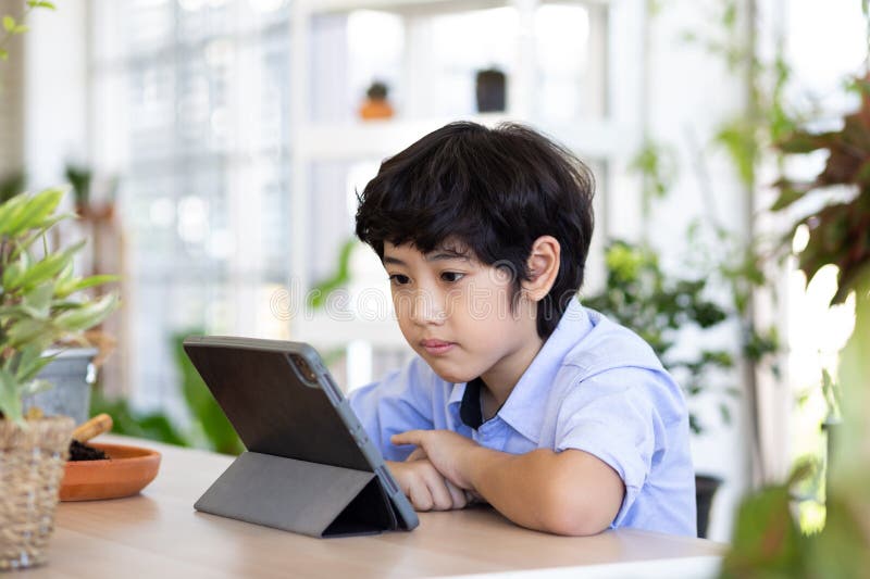 Child Looked Excited and Looked at the Tablet while Studying ...