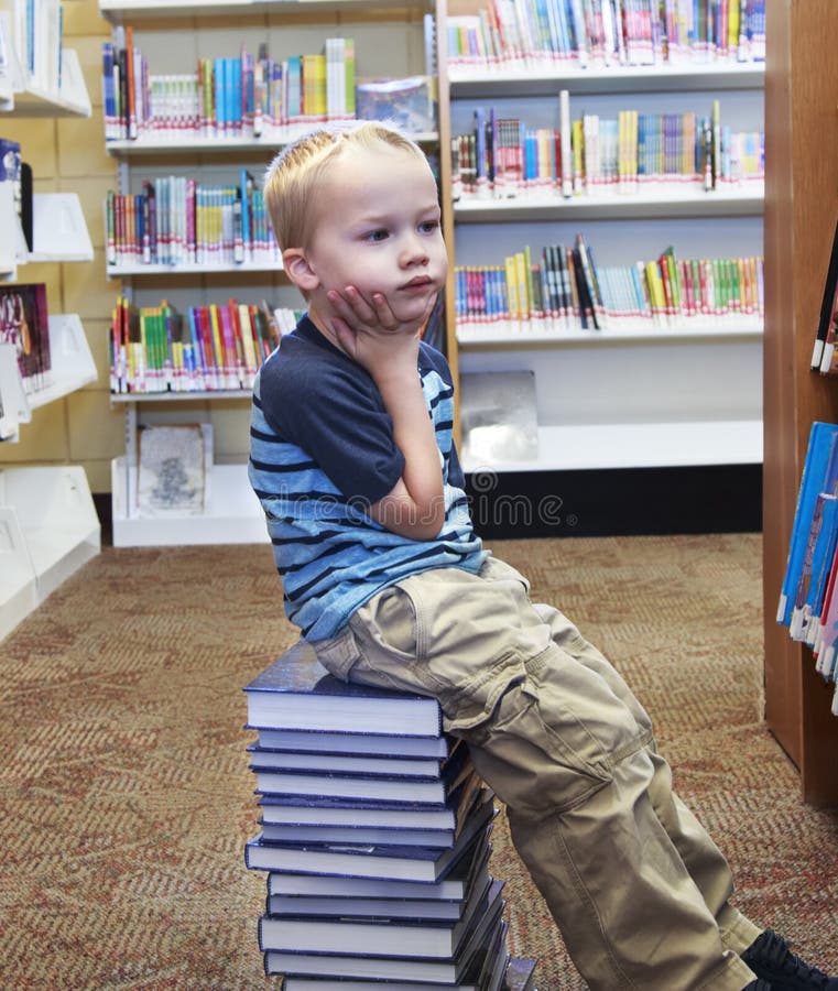 Child Choosing a Book from the Library Shelf Stock Image - Image of ...