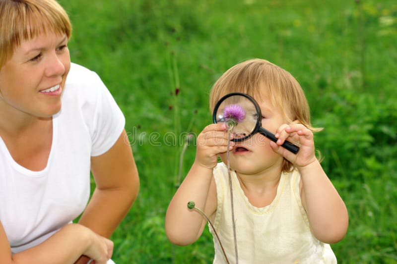 Child Looking at Flower through Magnifying Glass Stock Photo - Image of ...