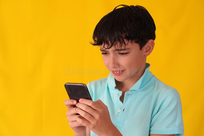 Child Looking at His Smartphone with a Gesture of Disgust and Sadness ...