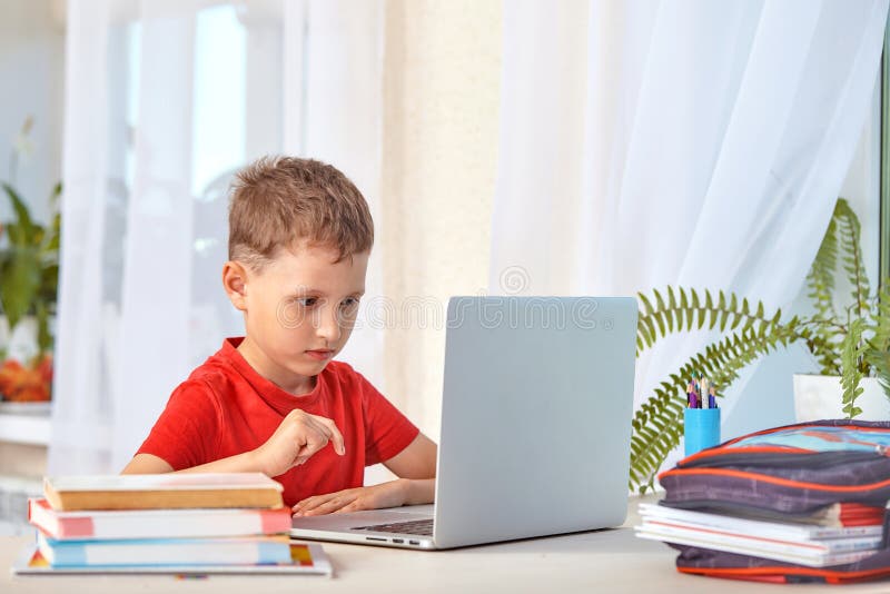 Child is Looking for Information on the Internet through a Laptop. Self ...