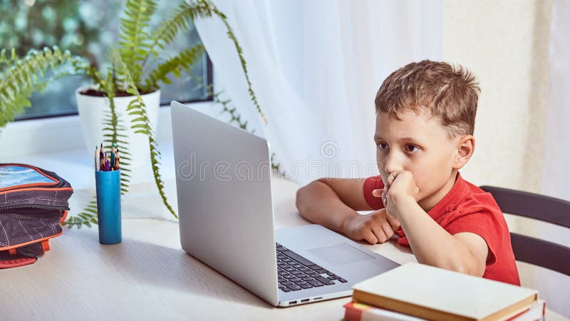 Child is Looking for Information on the Internet through a Laptop. Self ...