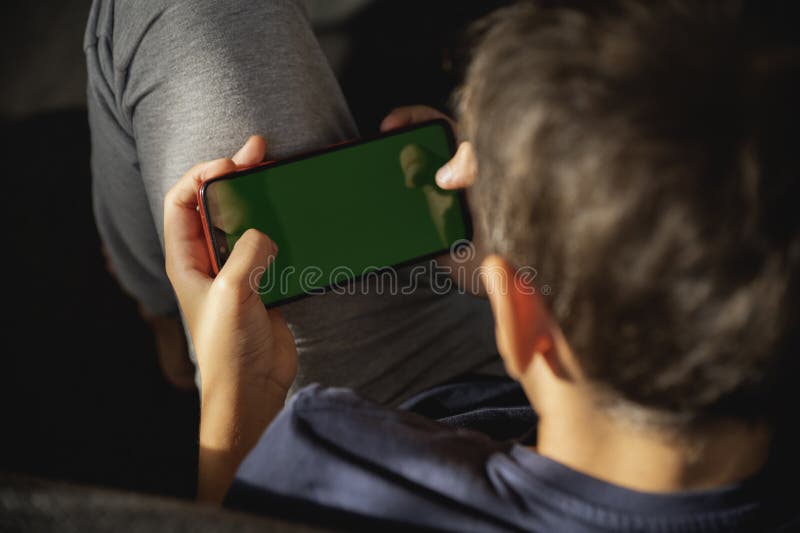 Child Looking at Phone Screen. Focus on Phone Stock Photo - Image of ...