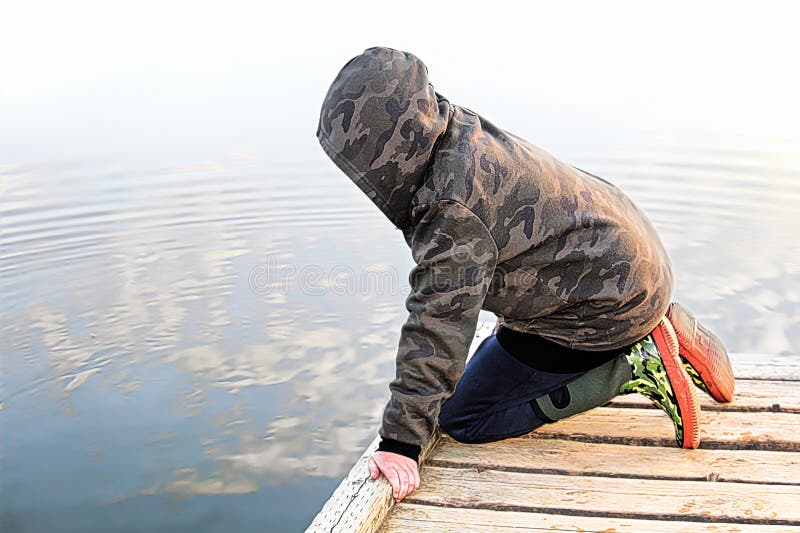 A Child Looking into Water with a Mirror Reflection of the Sky Stock ...