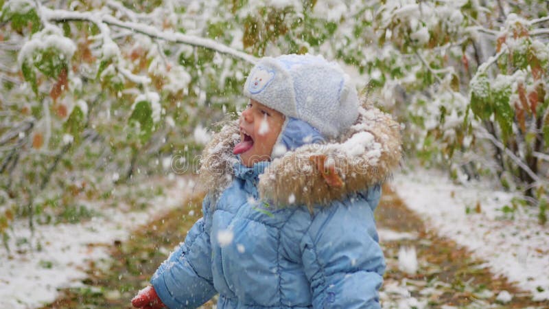 The Child Looks at the Snow Falling in the Park Stock Video - Video of ...