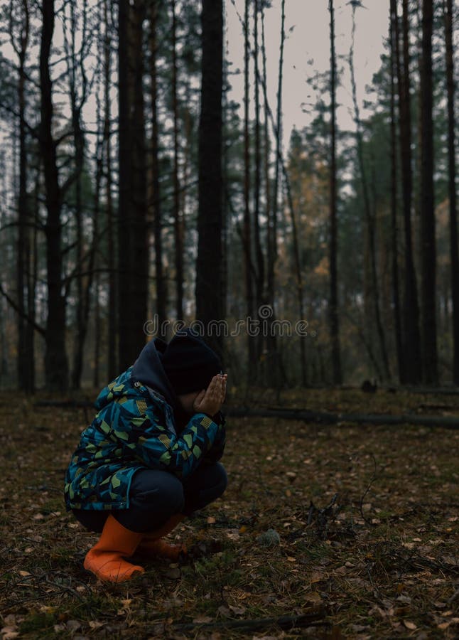 A Child is Lost in the Forest, Cries and Hides, Surrounded by Trees and ...