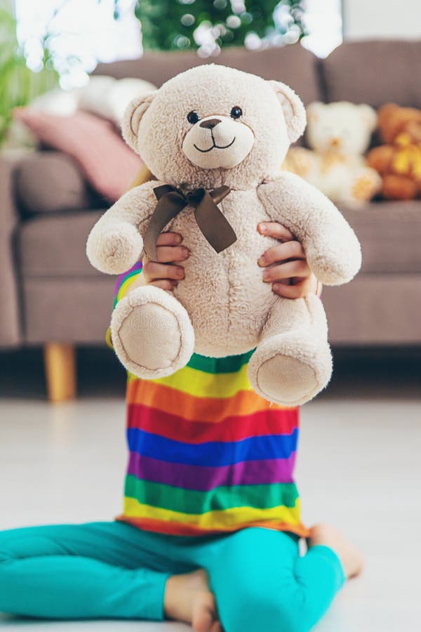 Child Loves Teddy Bear at Home. Selective Focus Stock Photo - Image of ...