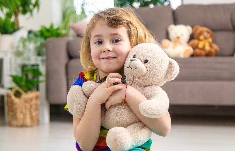 Child Loves Teddy Bear at Home. Selective Focus Stock Photo - Image of ...