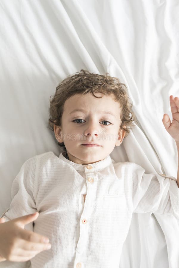 Child lying on the bed. stock photo. Image of lifestyle - 122897544