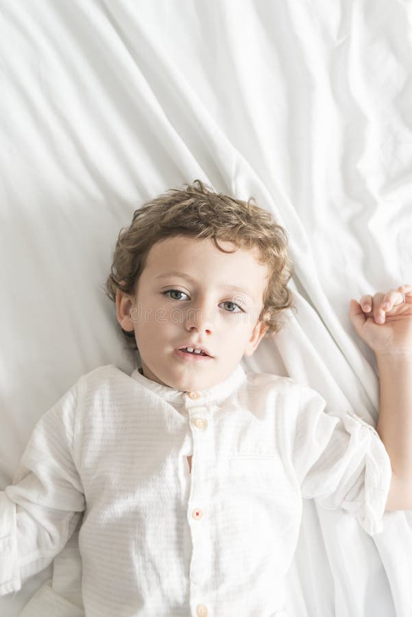 Child lying on the bed. stock image. Image of leisure - 122897771