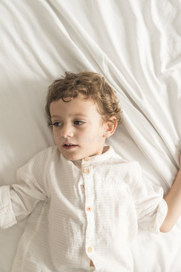Child lying on the bed. stock photo. Image of room, holiday - 122897264