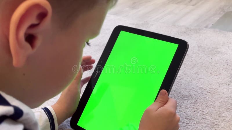 Child Using a Digital Tablet PC with Green Screen, Back View Stock ...