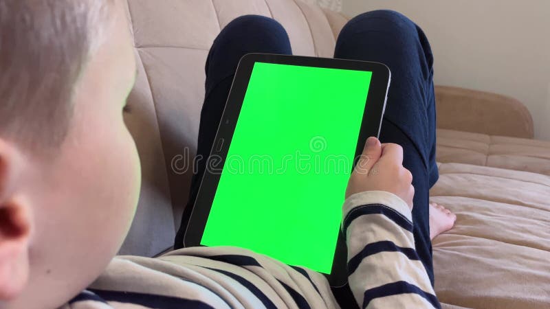 Child Using a Digital Tablet PC with Green Screen, Back View Stock ...