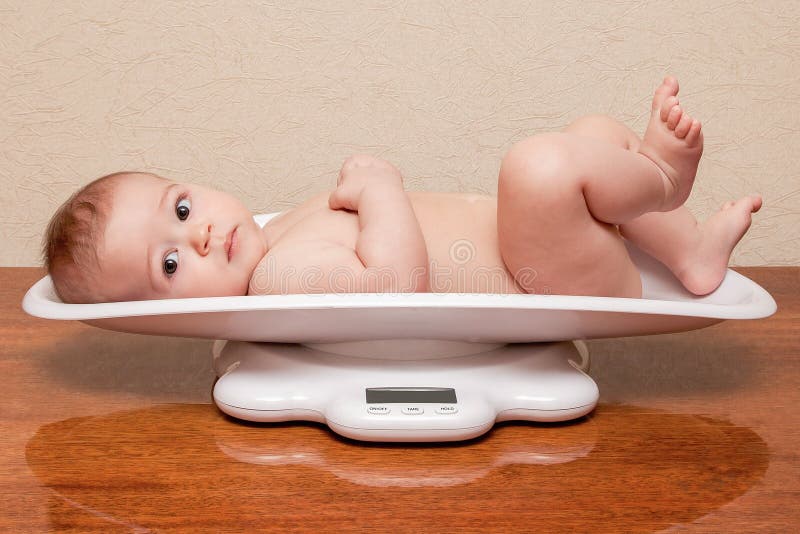 Child is lying on scales stock image. Image of close - 67473973
