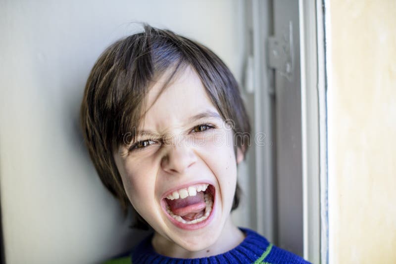 Child makes grimaces stock image. Image of close, home - 108380109