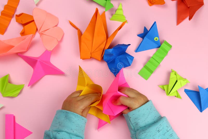 Child Makes Origami Crafts from Colored Paper Stock Photo - Image of ...