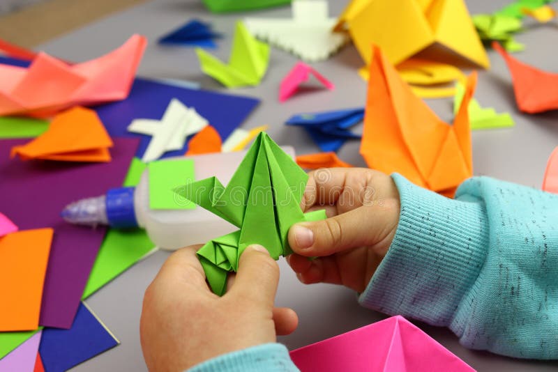 Child Makes Origami Crafts from Colored Paper Stock Photo - Image of ...