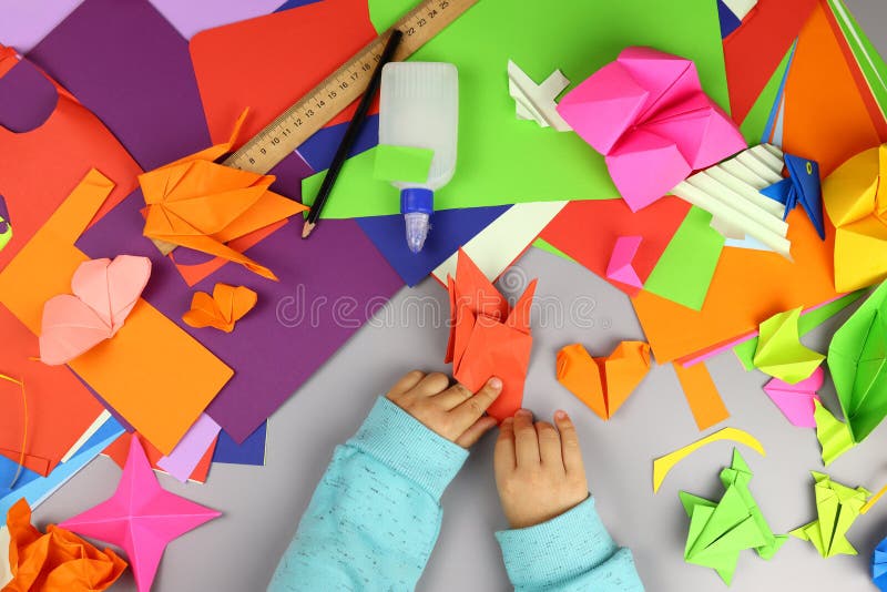 Child Makes Origami Crafts from Colored Paper, Hands Close-up Stock ...
