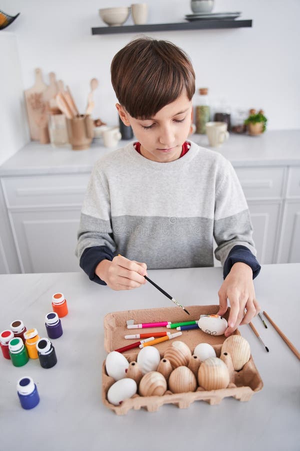 Child Making Different Easter Decorations on Wooden Table while Drawing ...