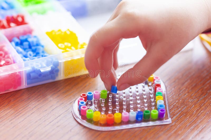 A Child Making a Heart from Plastic Beads Piece by Piece. Educational ...
