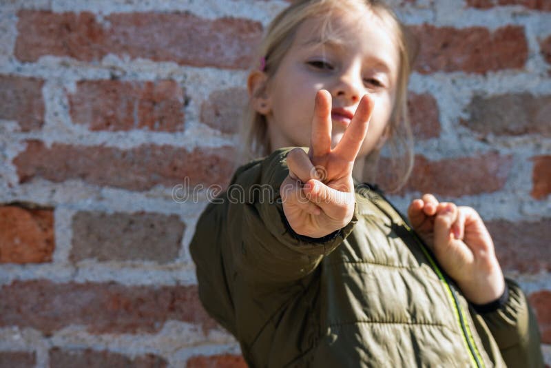 Child Making Peace Sign stock image. Image of child - 243096015