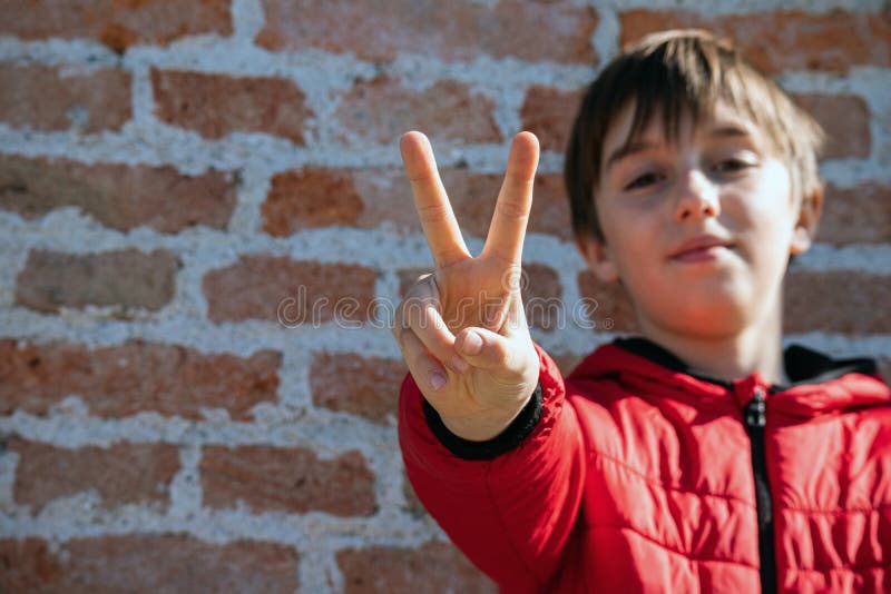 Child Making Peace Sign stock image. Image of child - 243096015