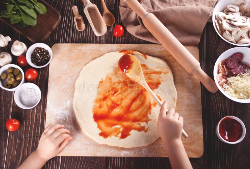 Child Making Pizza in the Home Kitchen. Top View. Stock Photo - Image ...