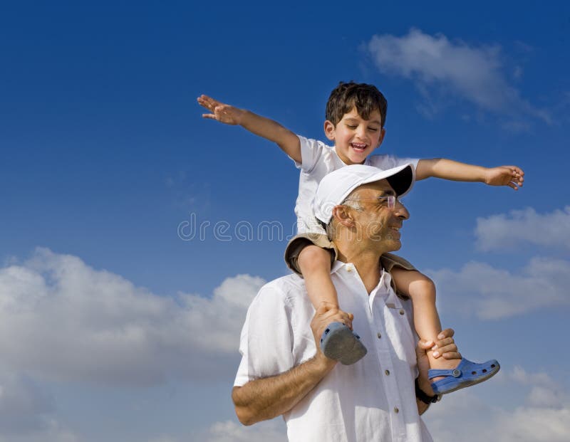 Child on man shoulders stock image. Image of blue, outside - 11335321