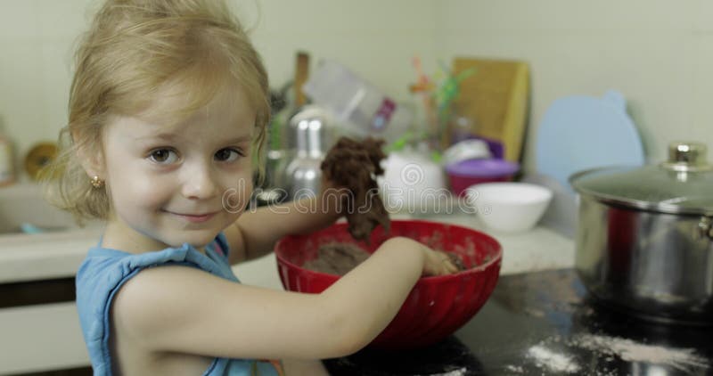 Child Mixing Chocolate Dough, Girl Making Cake in the Kitchen Stock ...