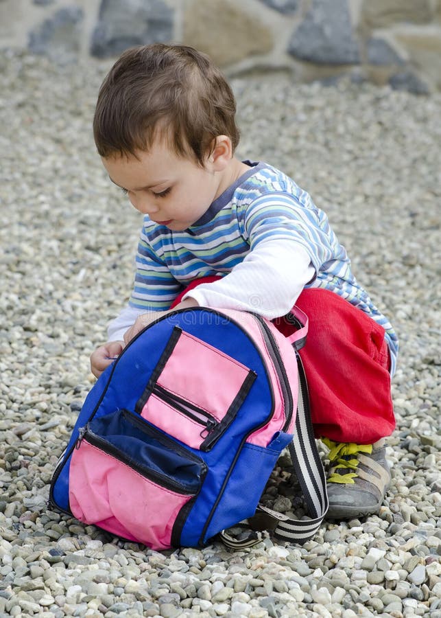 Child opening his bag stock image. Image of searching - 39320659