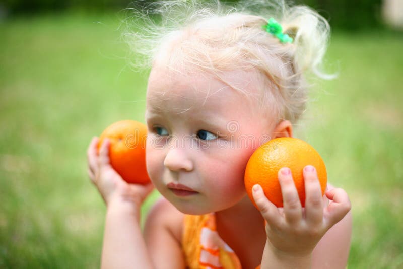 A child with oranges stock image. Image of orange, green - 24715677
