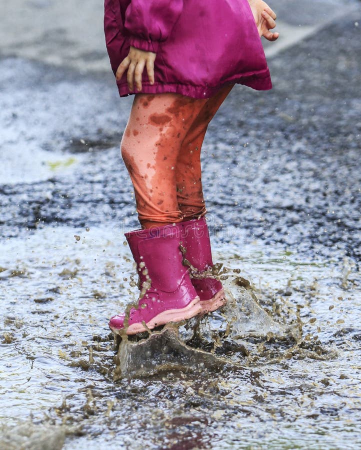 Child Outdoor Jump into Puddle in Boot after Rain Stock Photo - Image ...