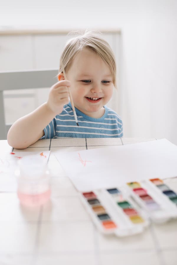 Child Painting and Drawing with Watercolor Paint at White Table ...