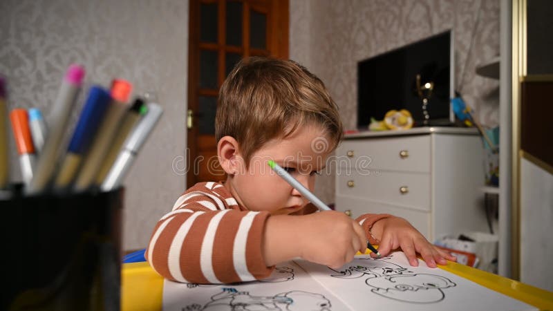 Child Paints a Coloring Book. Child Development To Creativity Stock ...