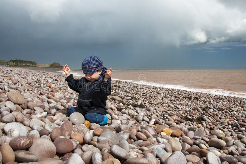 Child on a Pebble Beach in Devon, England Stock Photo - Image of ...
