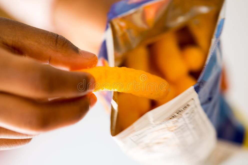 Child Picking Cheese Puffs Snack from Pack Stock Image - Image of ...