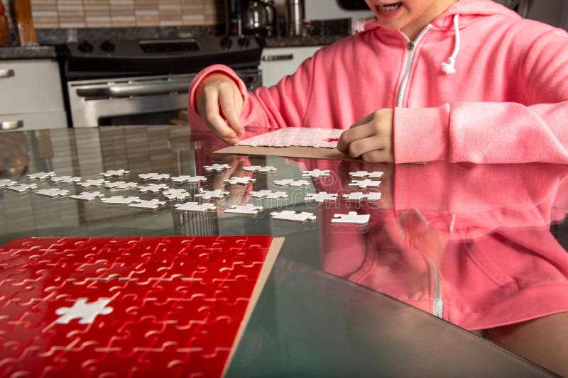Child Assembling Puzzle in Kitchen Stock Photo - Image of pink, family ...