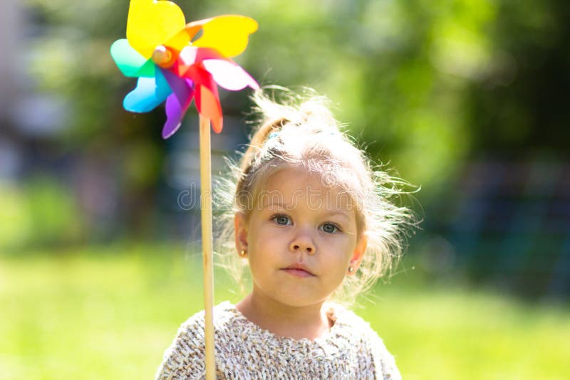 Child with Pinwheel in the Summer Park Looking at Camera Stock Image ...