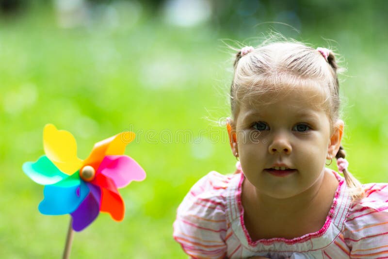 Child with Pinwheel in the Summer Park Looking at Camera Stock Image ...