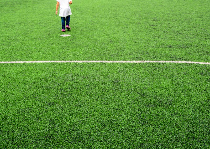 Child Play on the Artificial Turf Stock Photo - Image of pavement ...