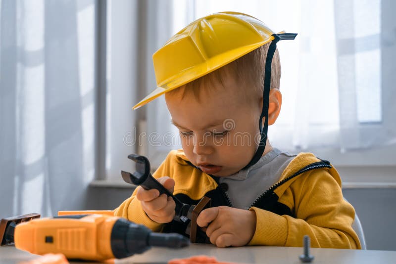 Child Play with Work Tools at Home, Dreams To Be an Engineer. Little ...