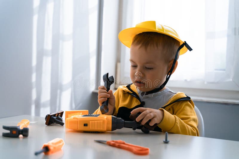 Child Play with Work Tools at Home, Dreams To Be an Engineer. Little ...