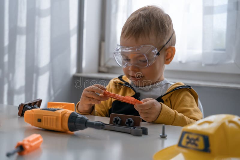 Child Play with Work Tools at Home, Dreams To Be an Engineer. Little ...