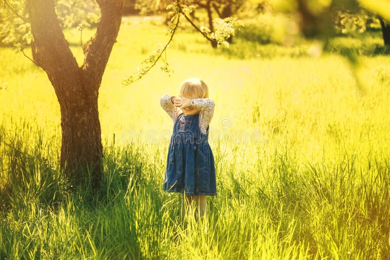 Child Playing Alone in Sunny Garden Stock Image - Image of child ...