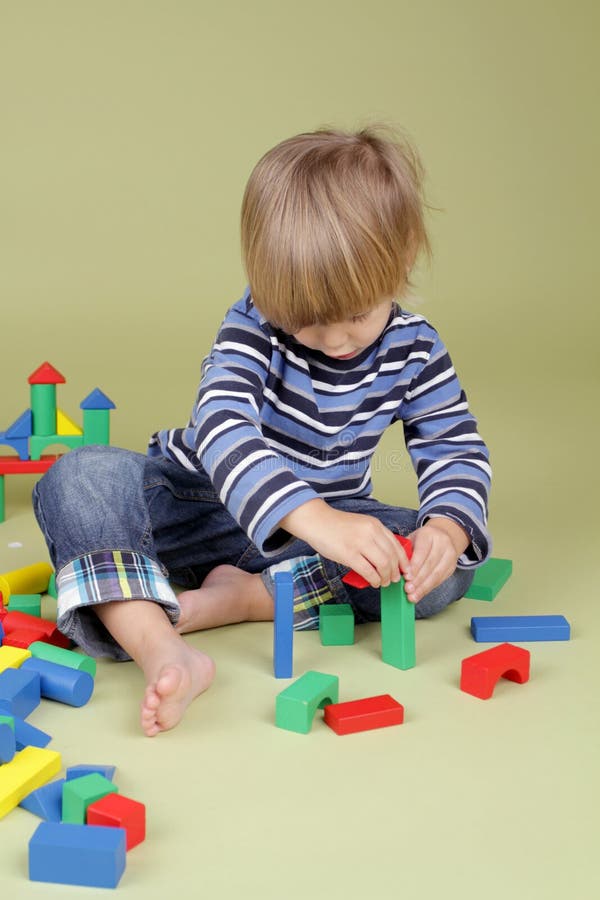 Child Playing with Blocks stock photo. Image of busy - 46852914