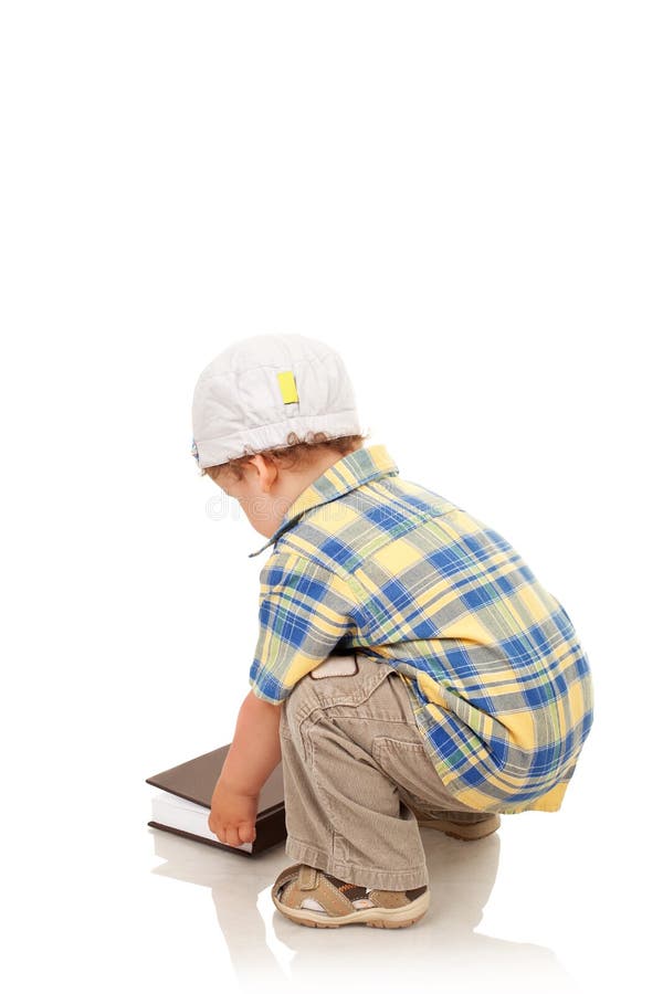 Child playing with a book stock photo. Image of straight - 20286948