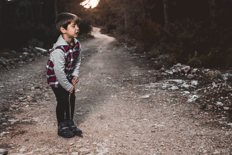 Child Playing with a Branch from a Tree in the Field. Happy Kid Playing ...