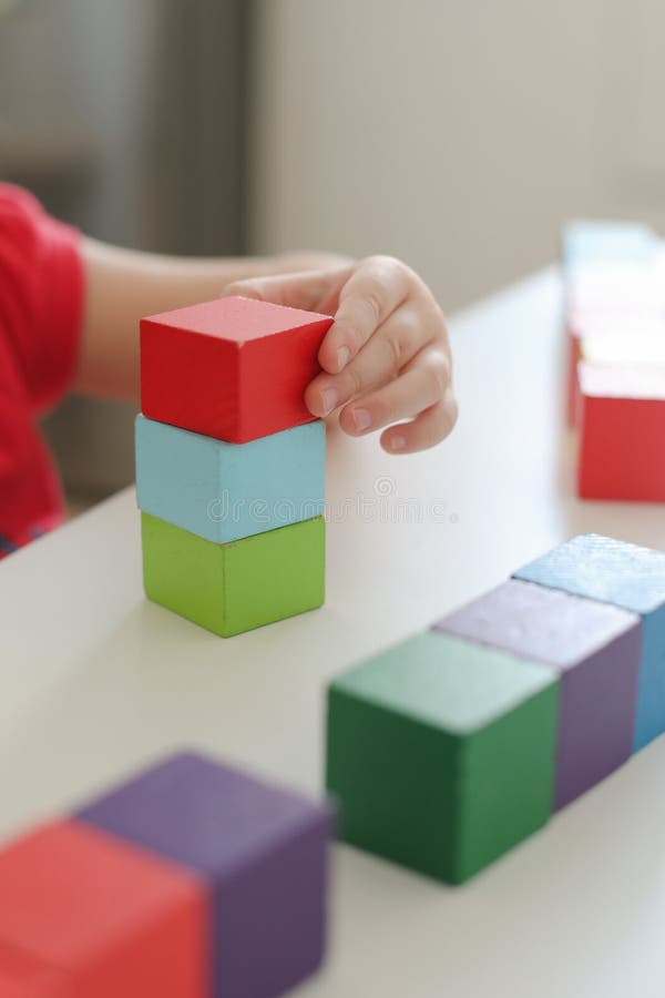 Child Playing and Building with Colorful Wooden Toy Bricks on White ...
