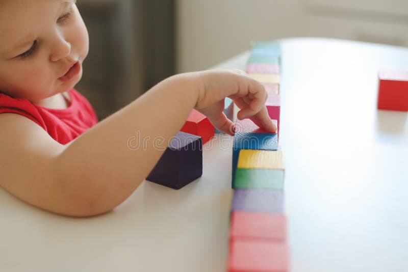 Child Playing and Building with Colorful Wooden Toy Bricks on White ...