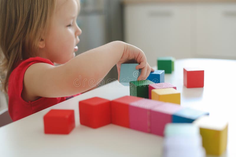 Child Playing and Building with Colorful Wooden Toy Bricks on White ...